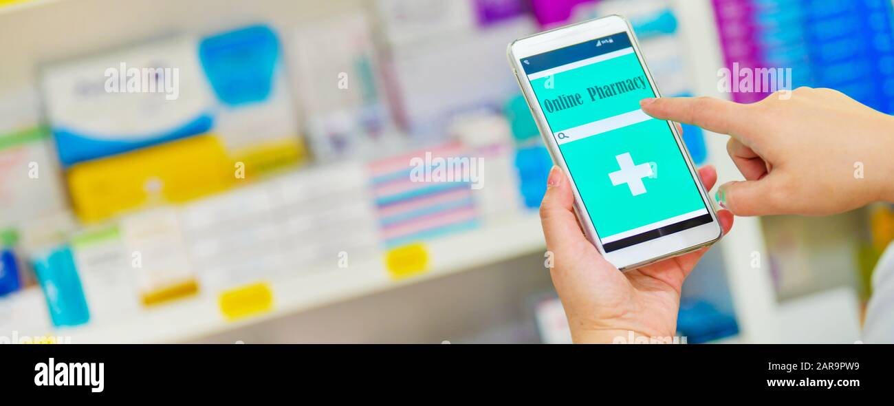 Pharmacist using mobile smart phone for search bar on display in ...