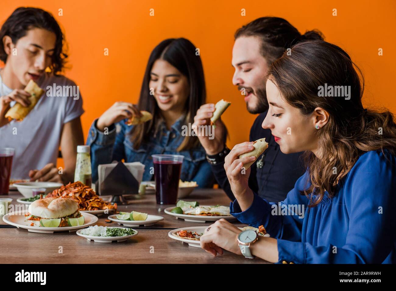 Mexican people eating Tacos al Pastor in a Taqueria in Mexico city ...
