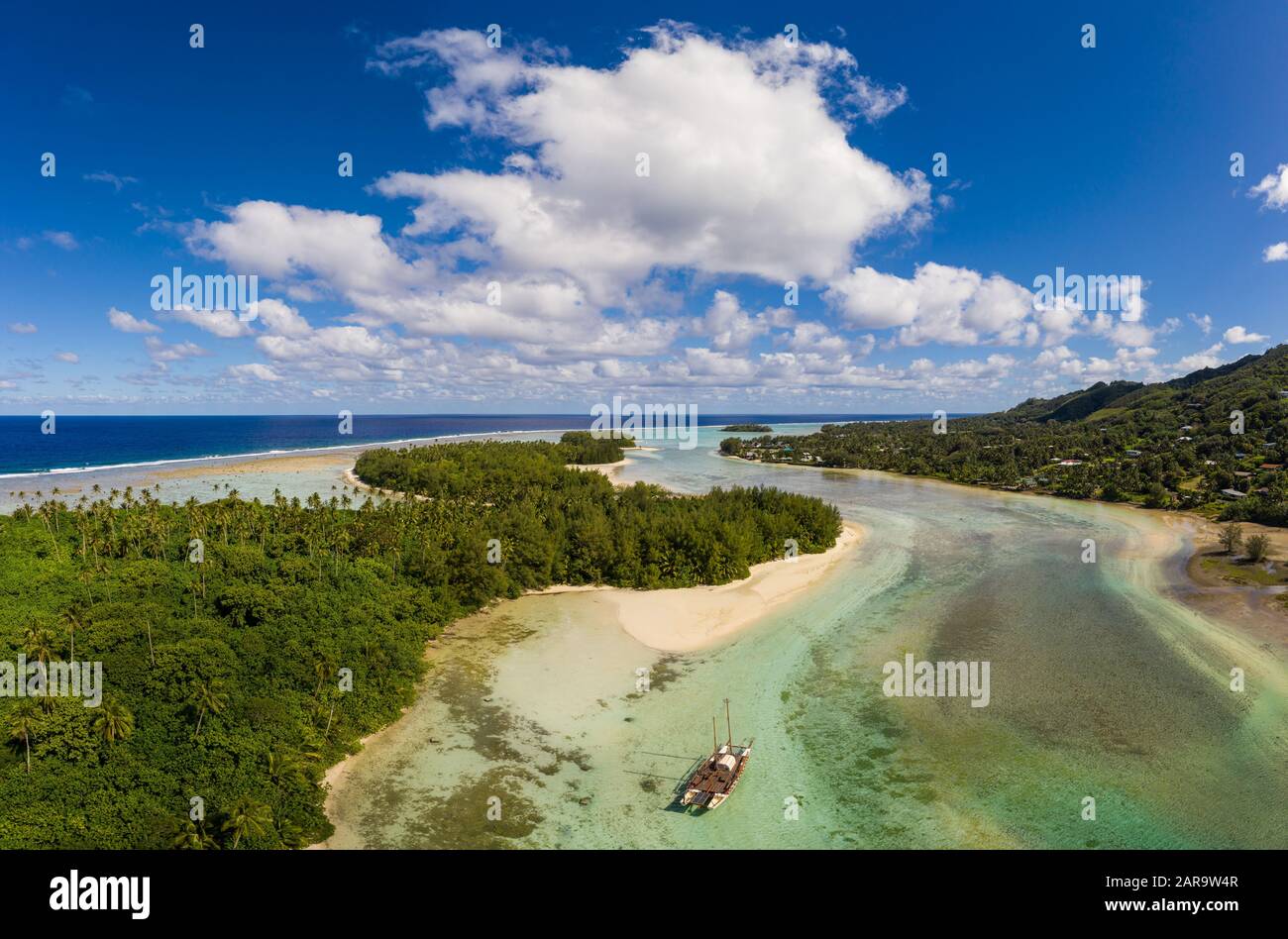 Aerial view of the Muri lagoon with a sailboat in Rarotonga in the Cook ...