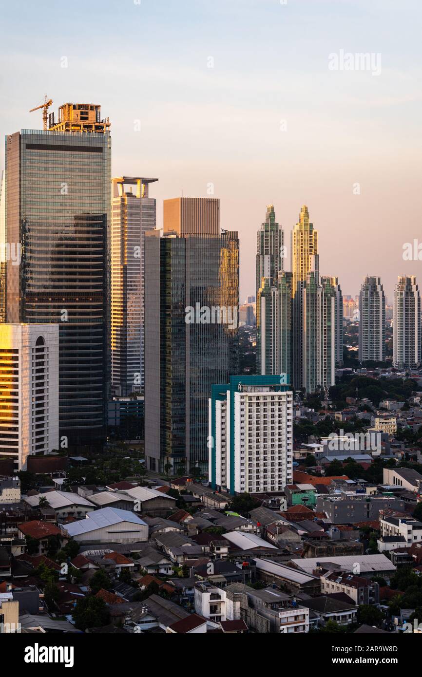 Sunset over Jakarta skyline where modern luxury condo and office towers ...