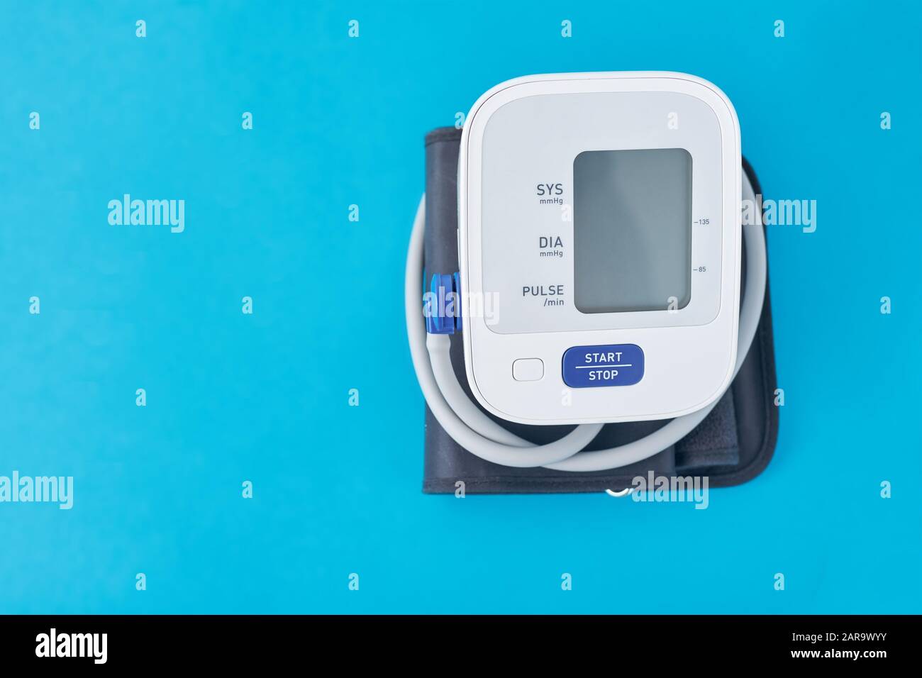 Digital blood pressure monitor on blue background, closeup. Helathcare ...