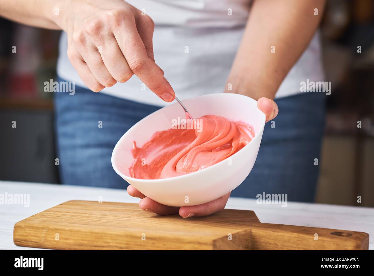Woman whisking red cream hi-res stock photography and images - Alamy