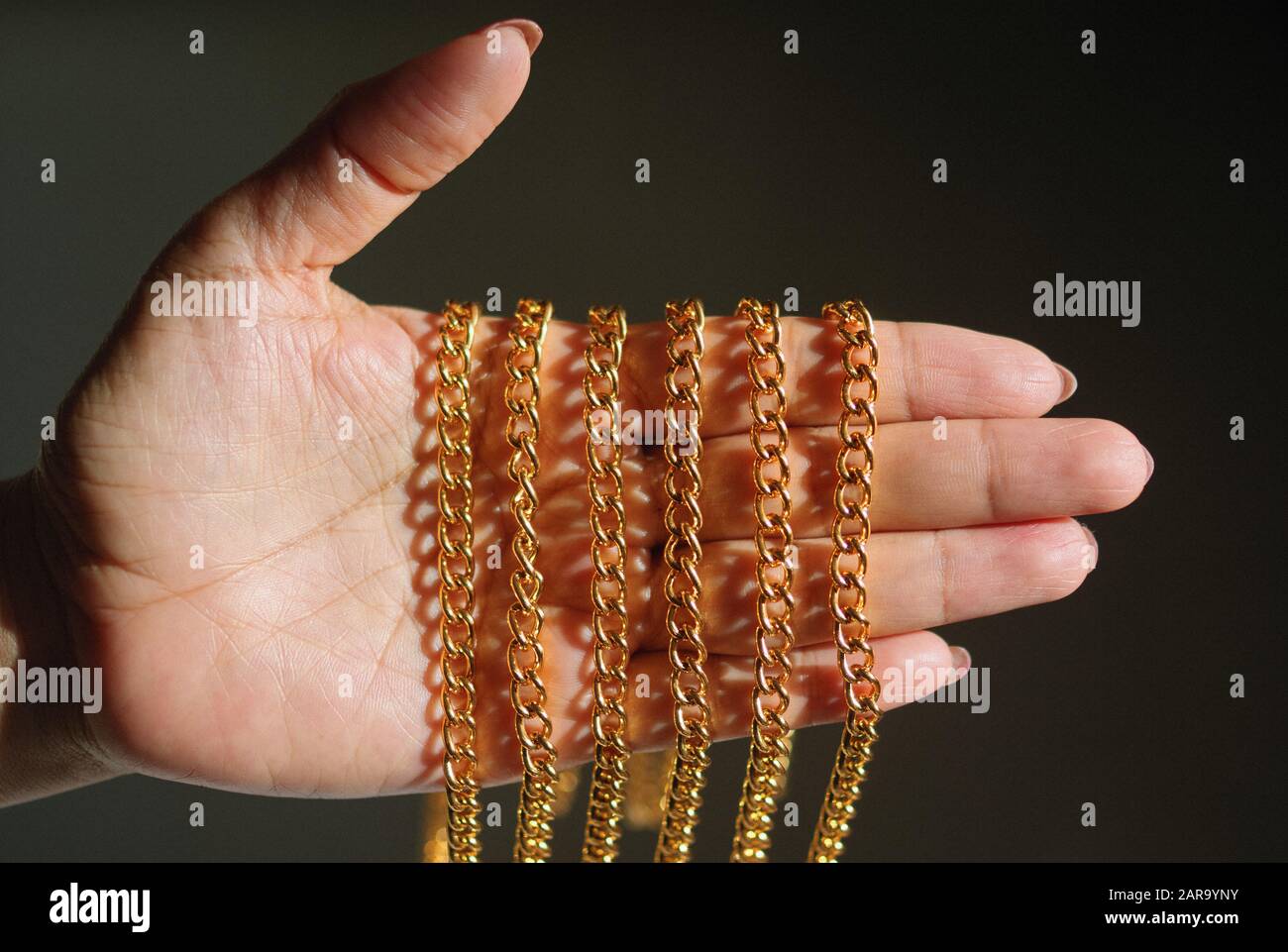 Hand holding expensive gold jewelry hi-res stock photography and images ...