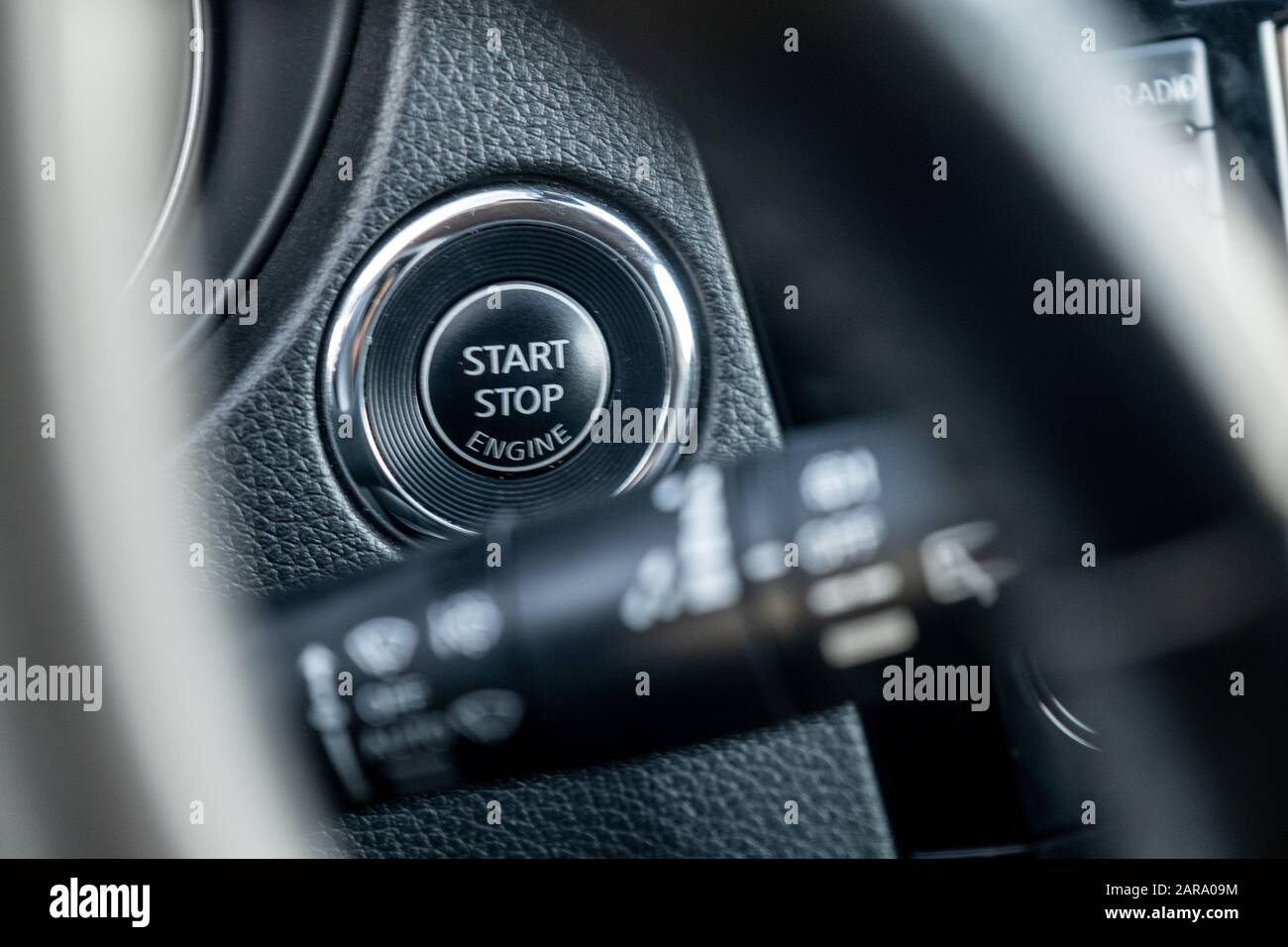 Detail on a black start button in a car. Vehicle engine start stop ...