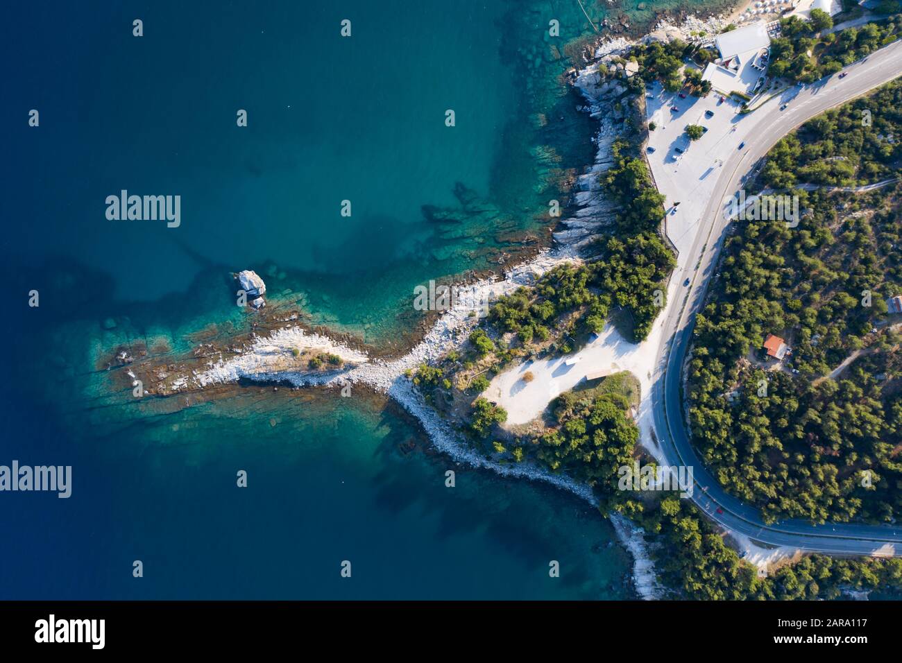 Aerial view from flying drone of a small peninsula with calm turquoise ...