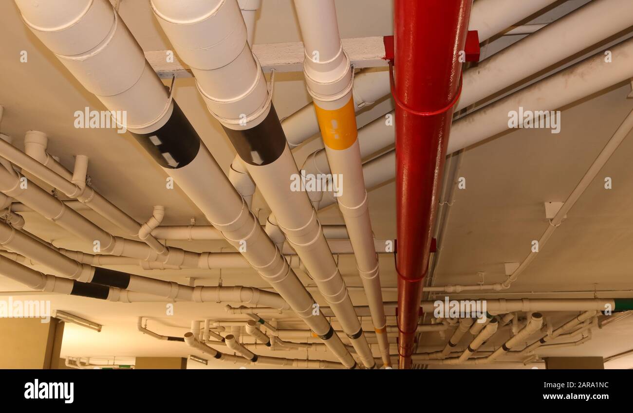 Water distribution system pipes installed by hanging from ceiling ...