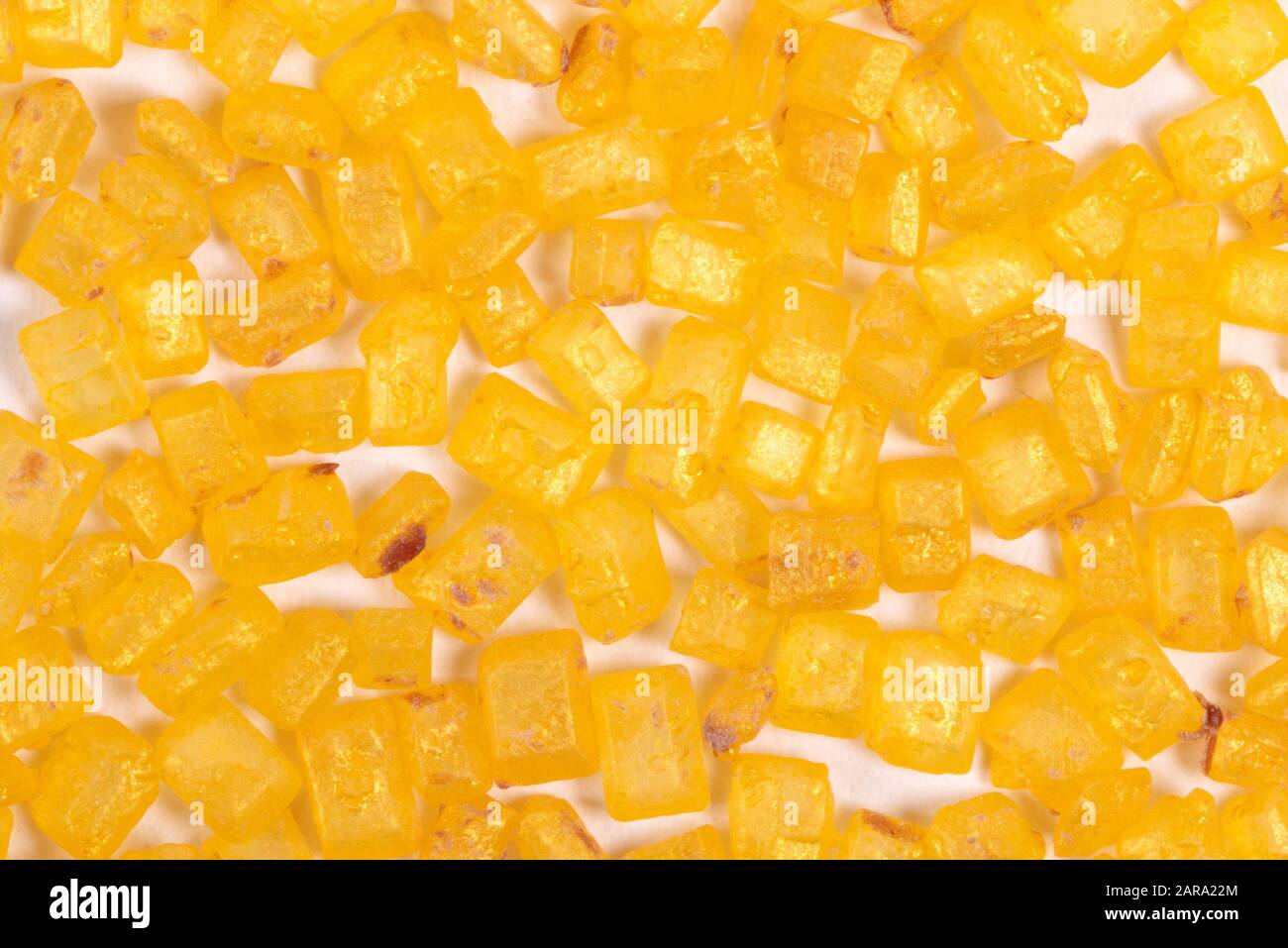 Gold colored sugar, isolated on a white background Stock Photo - Alamy
