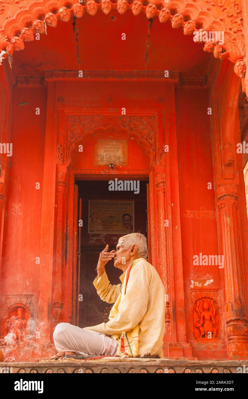 In the morning, man praying at ghats of holy Ganges river, also Ganga ...