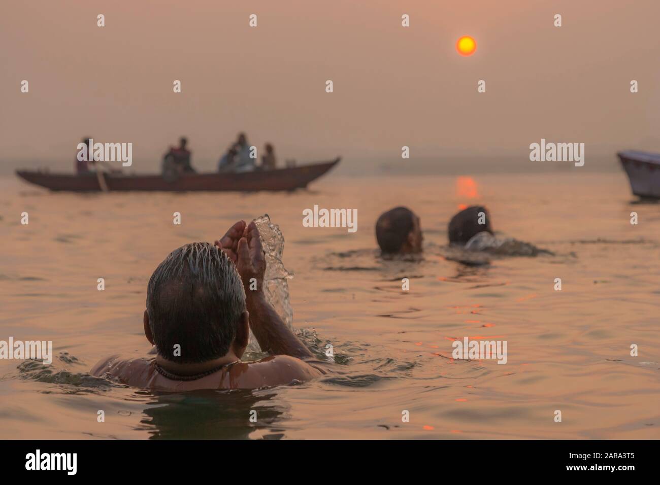 Men bathing in morning at ghats of holy Ganges river, also Ganga river ...