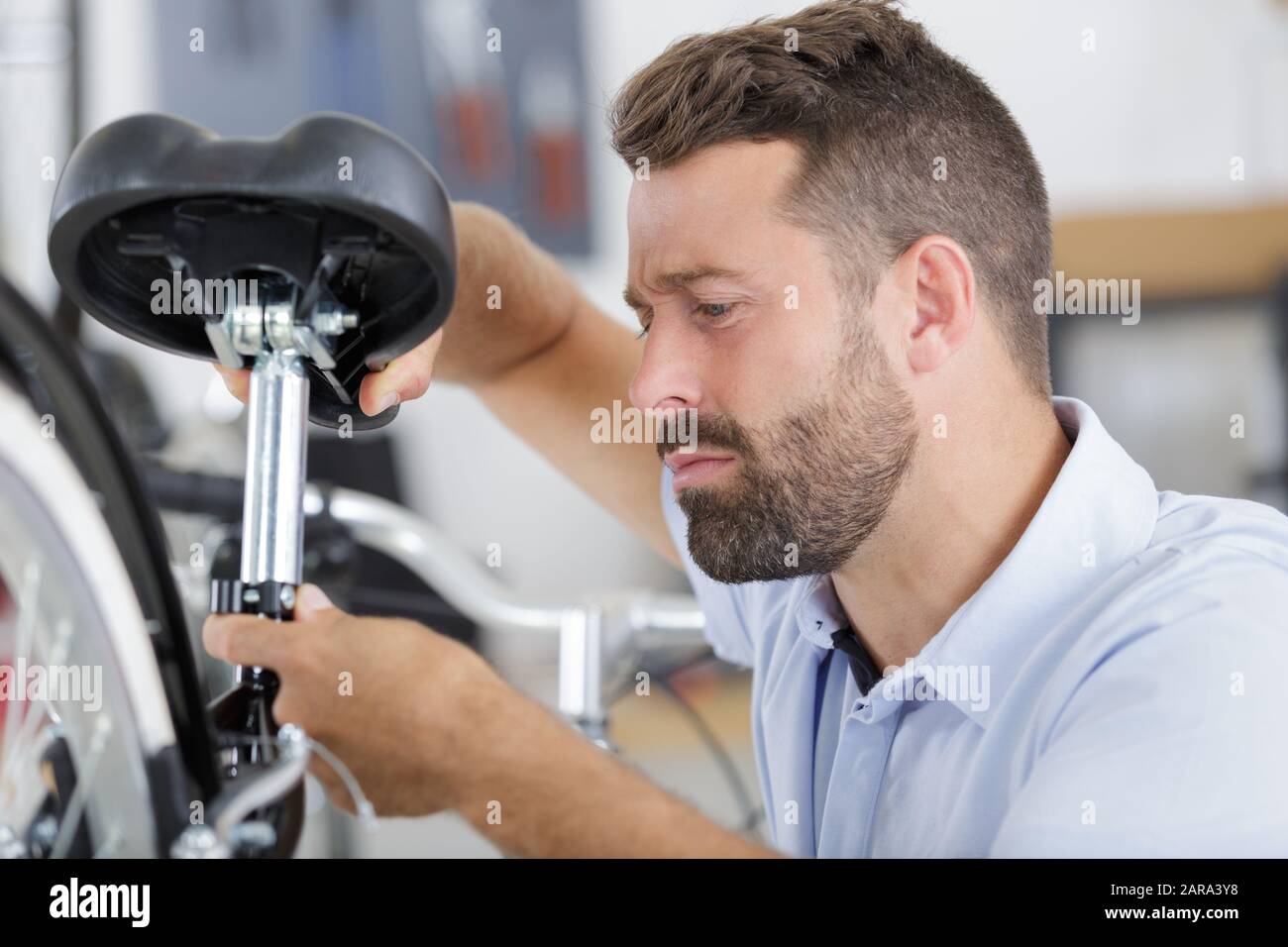 a man fixing a bike Stock Photo - Alamy
