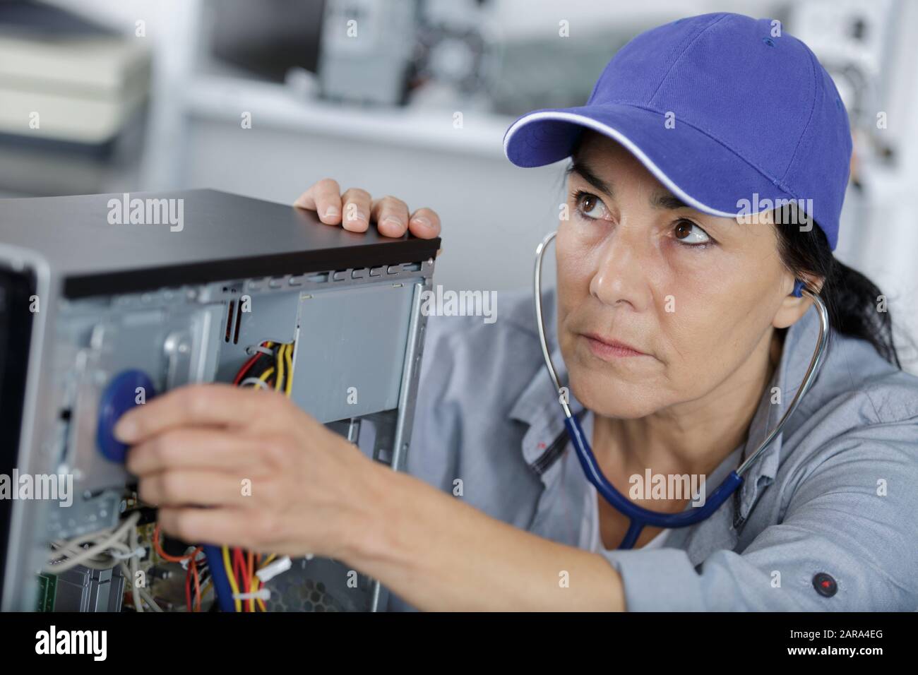 woman examined her computer with a stethoscope Stock Photo - Alamy