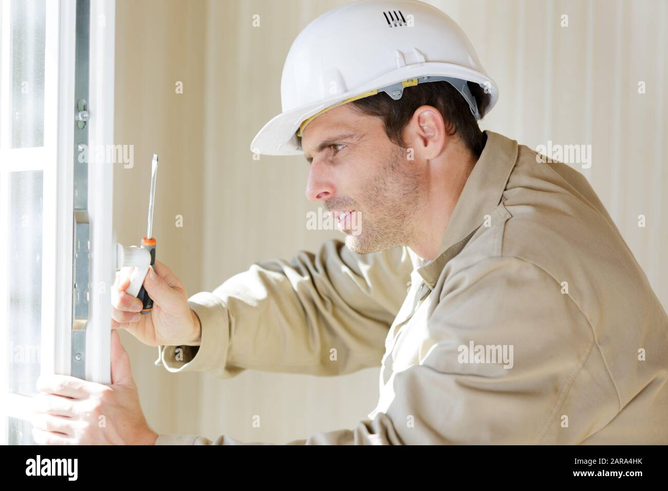 window builder working on mount of new installation Stock Photo - Alamy