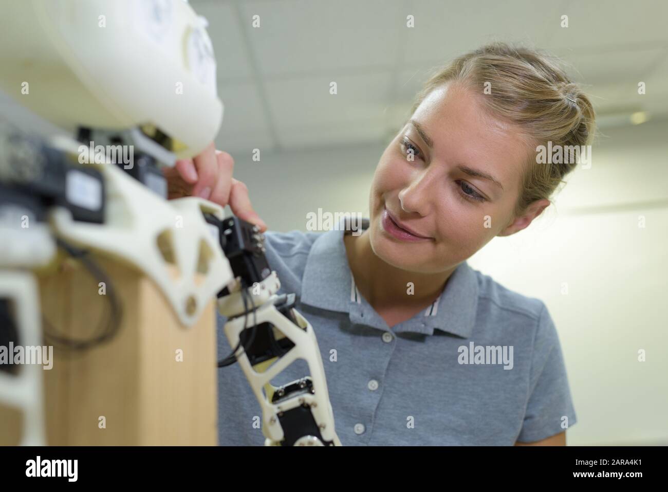 a woman fixing robotic arm Stock Photo - Alamy