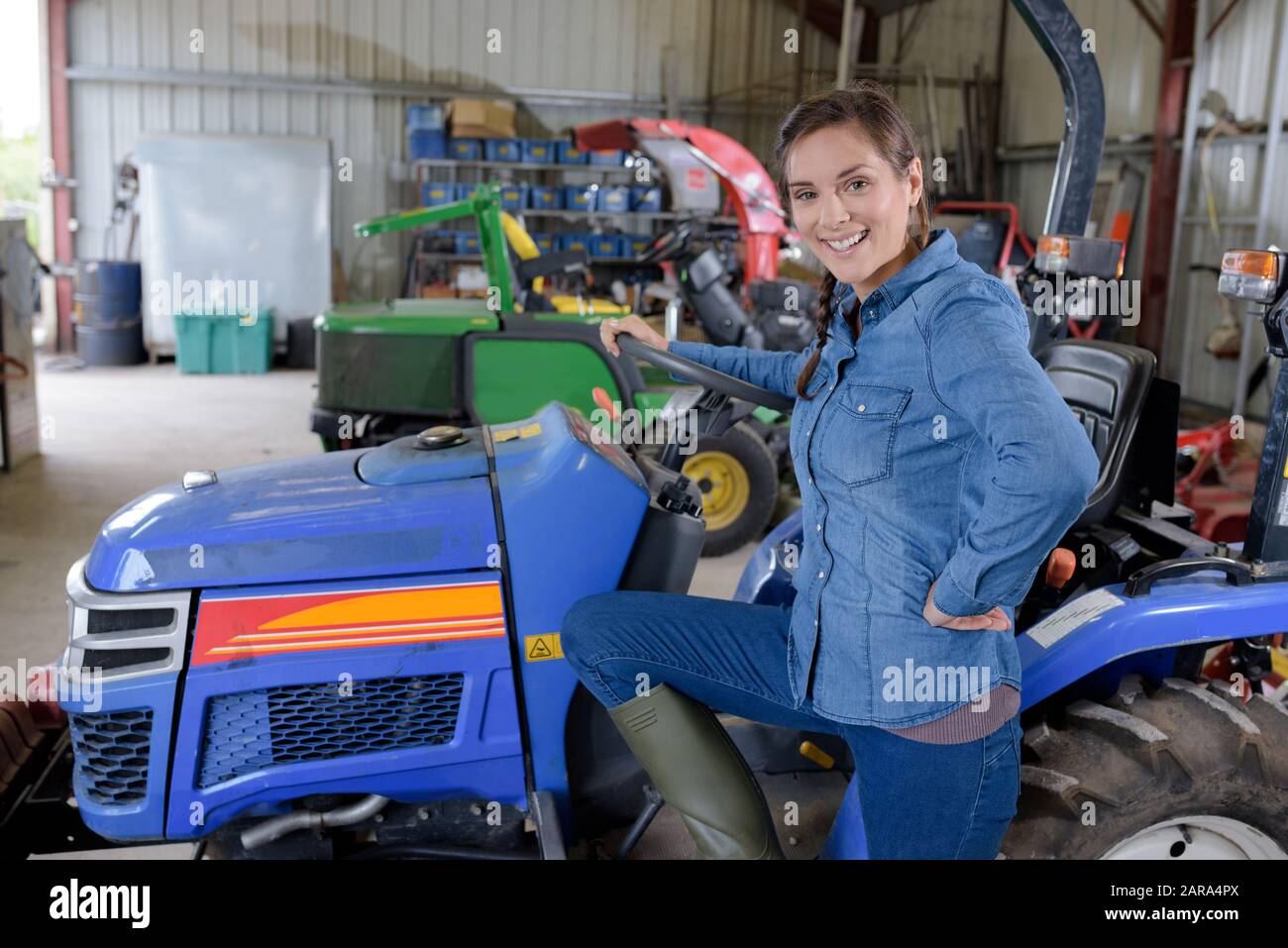 mechanical female in a tractor garage Stock Photo - Alamy