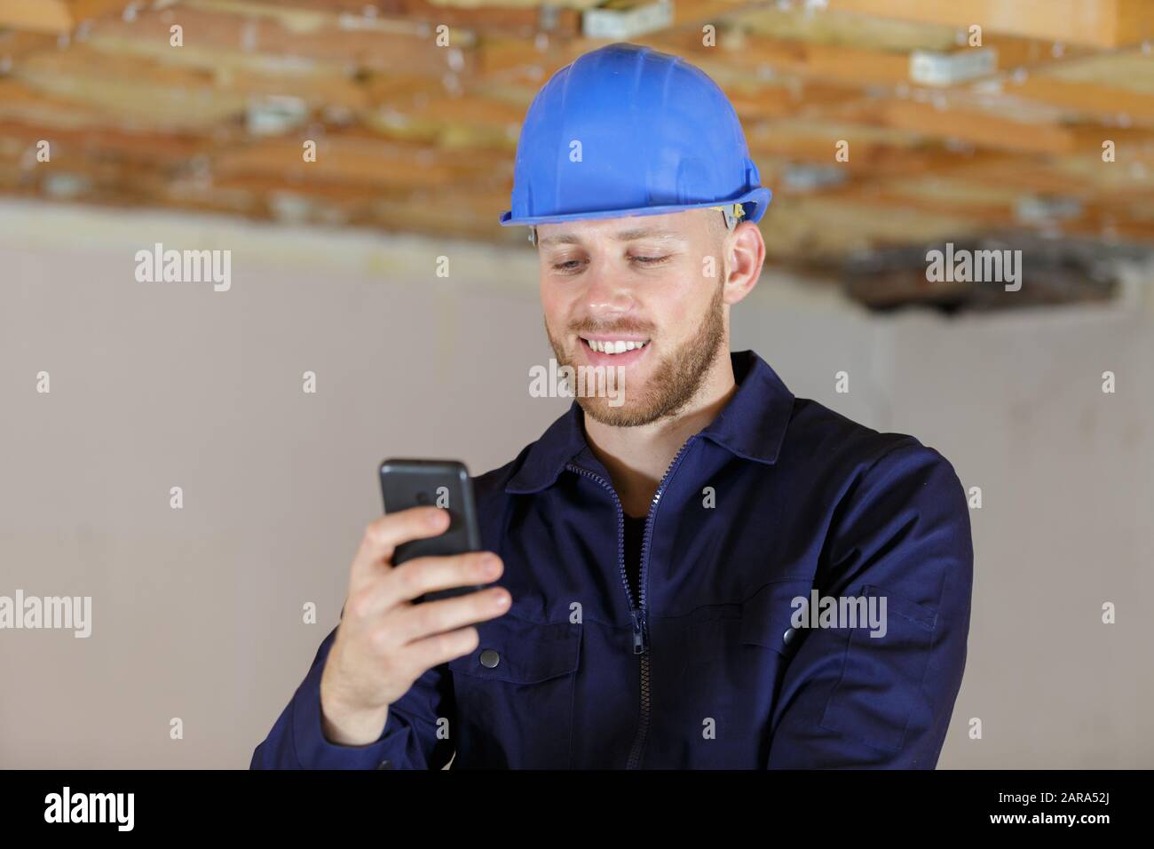 male engineer holding mobile phone Stock Photo - Alamy