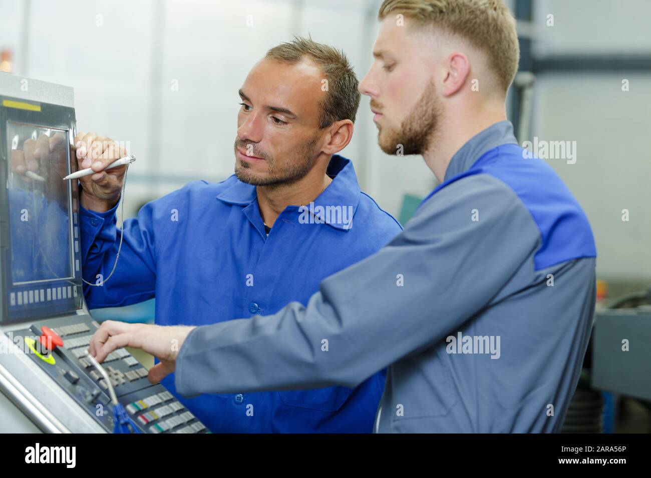 men and the machine operation Stock Photo - Alamy