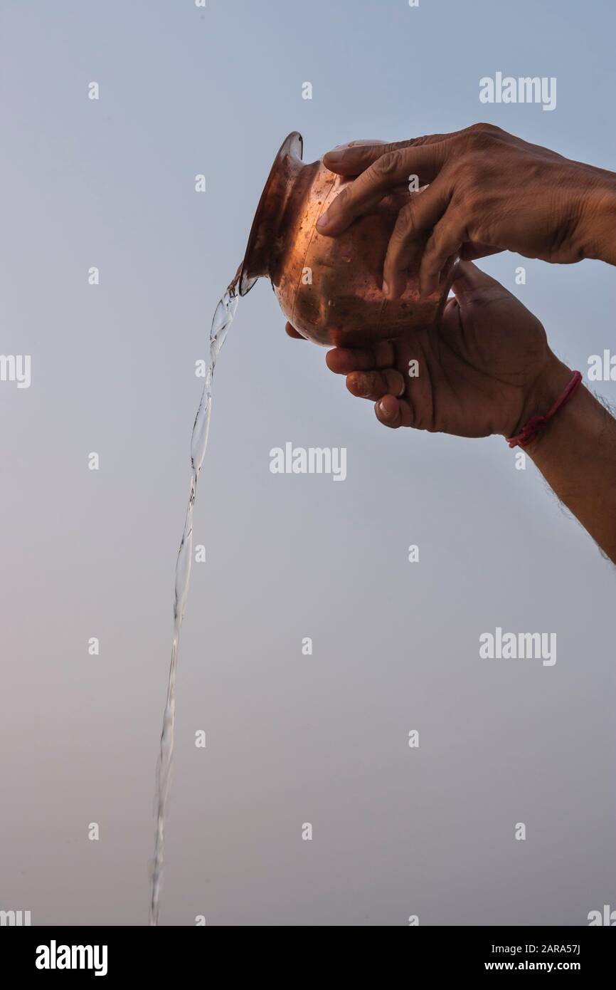 Woman praying with water, at ghats of holy Ganges river, also Ganga ...