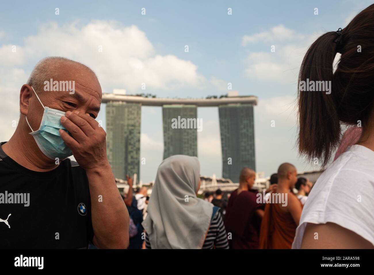 26.01.2020, Singapore, Republic of Singapore, Asia - A man covers his ...