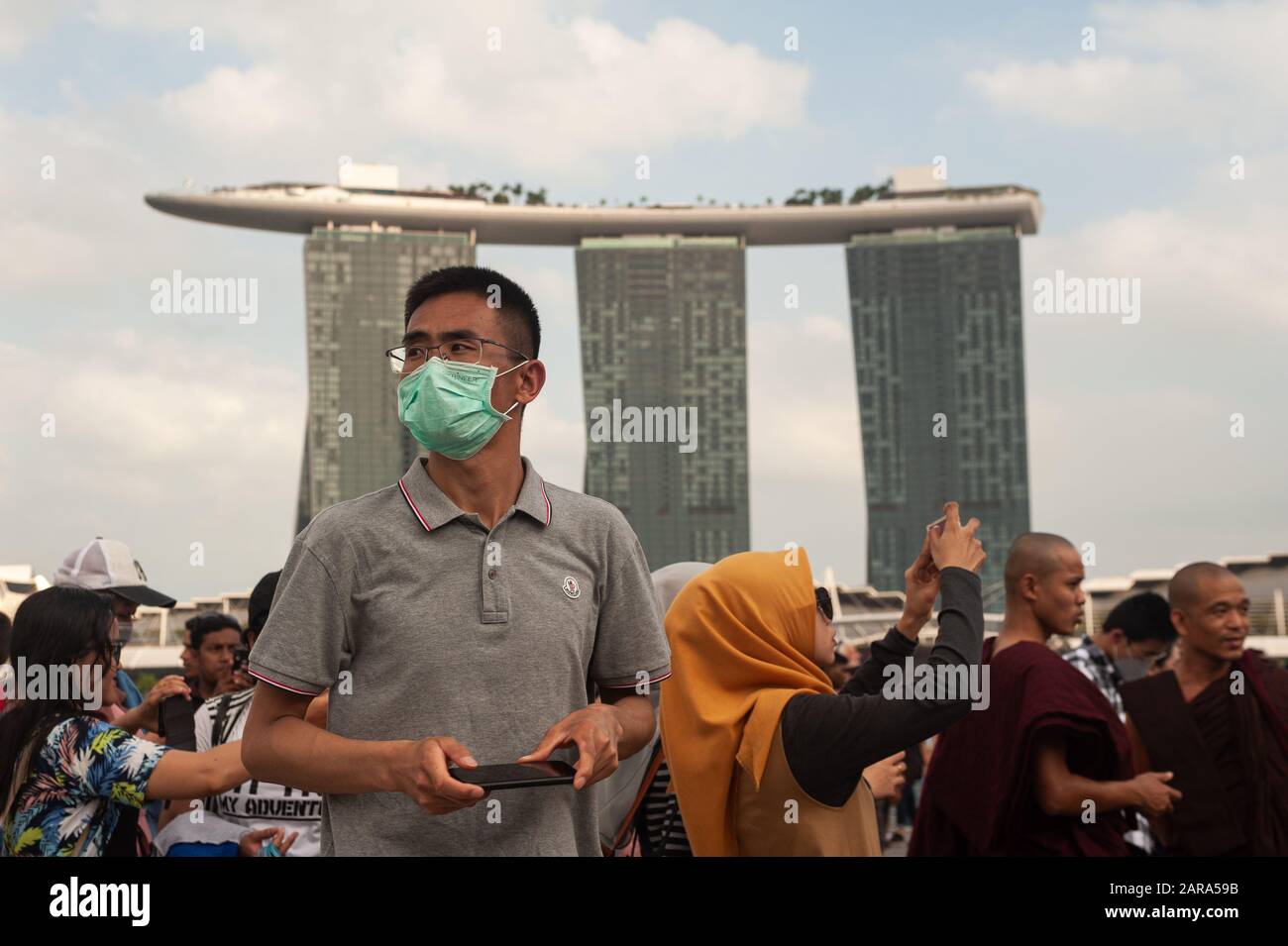 26.01.2020, Singapore, Republic of Singapore, Asia - A man covers his ...