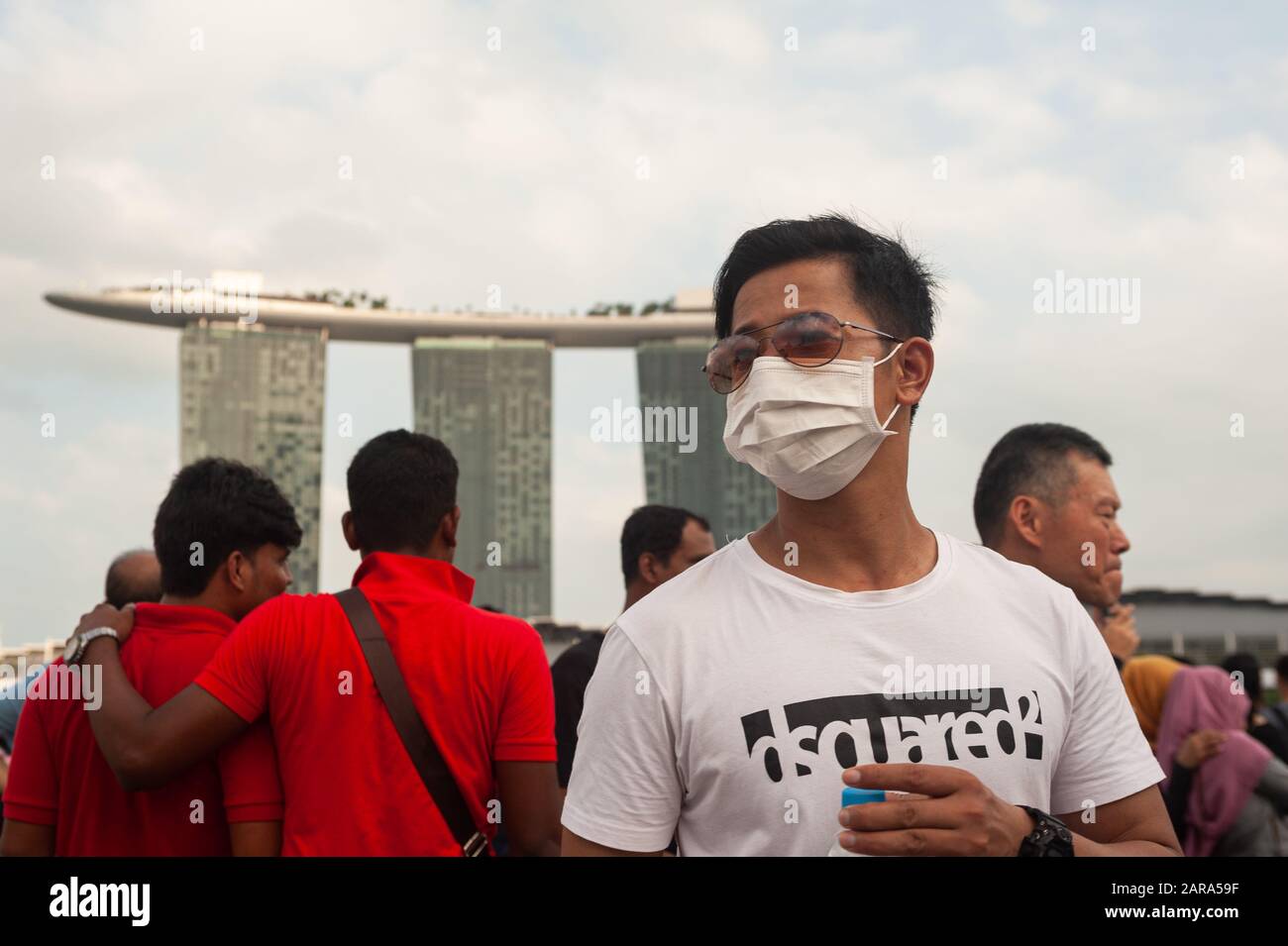 26.01.2020, Singapore, Republic of Singapore, Asia - A man covers his ...