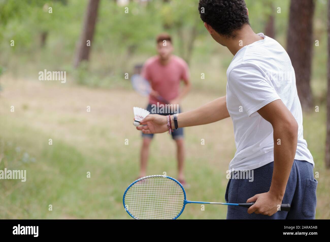 two men playing badminton outdoors Stock Photo - Alamy