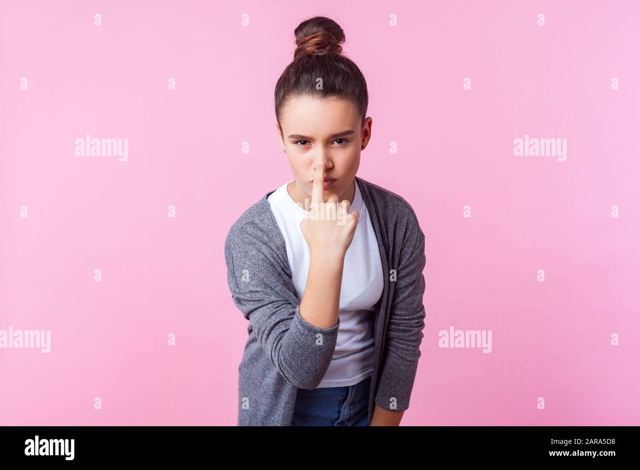 You are liar! Portrait of cute brunette teenage girl with bun hairstyle ...