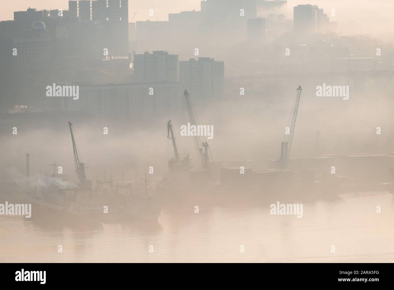 Cityscape daylight view. Fog over the city Stock Photo - Alamy