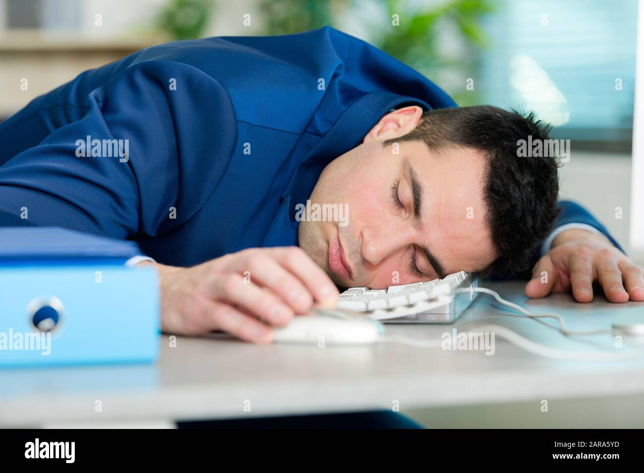 businessman sleeping on a desk Stock Photo - Alamy