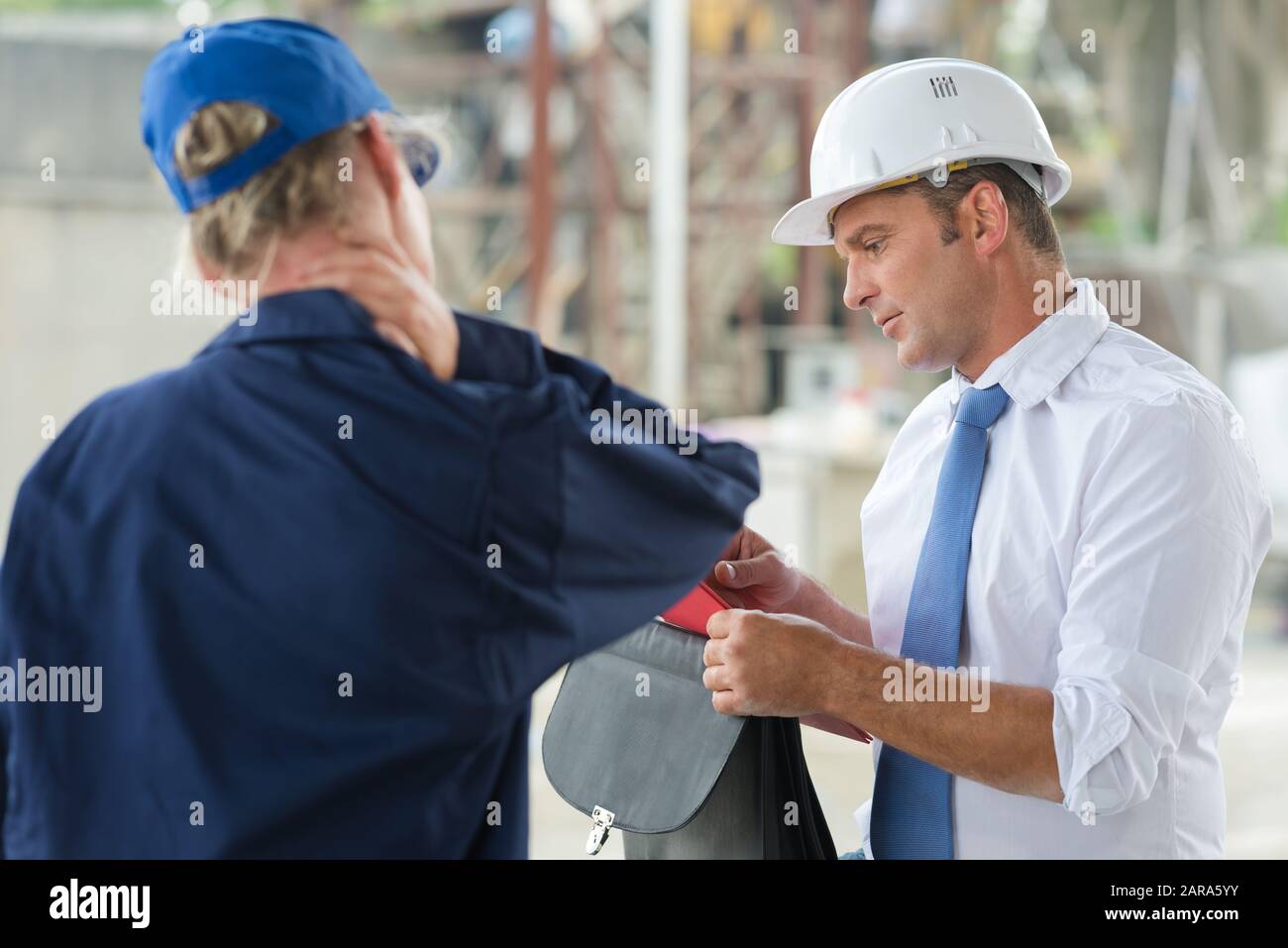 manager and female technician talking in factory Stock Photo - Alamy