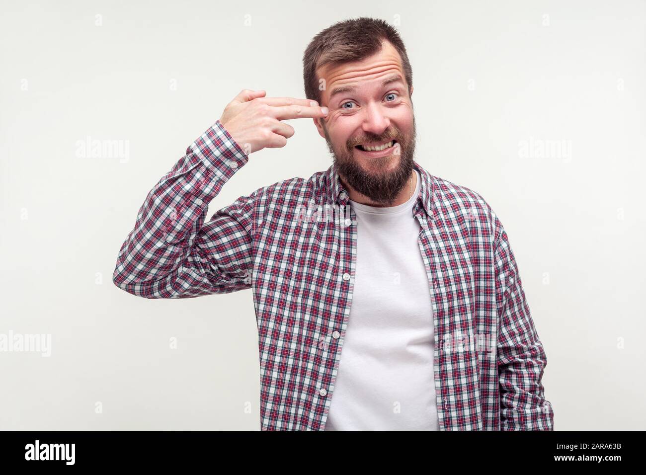 Kill me. Portrait of crazy tired bearded man in casual plaid shirt ...