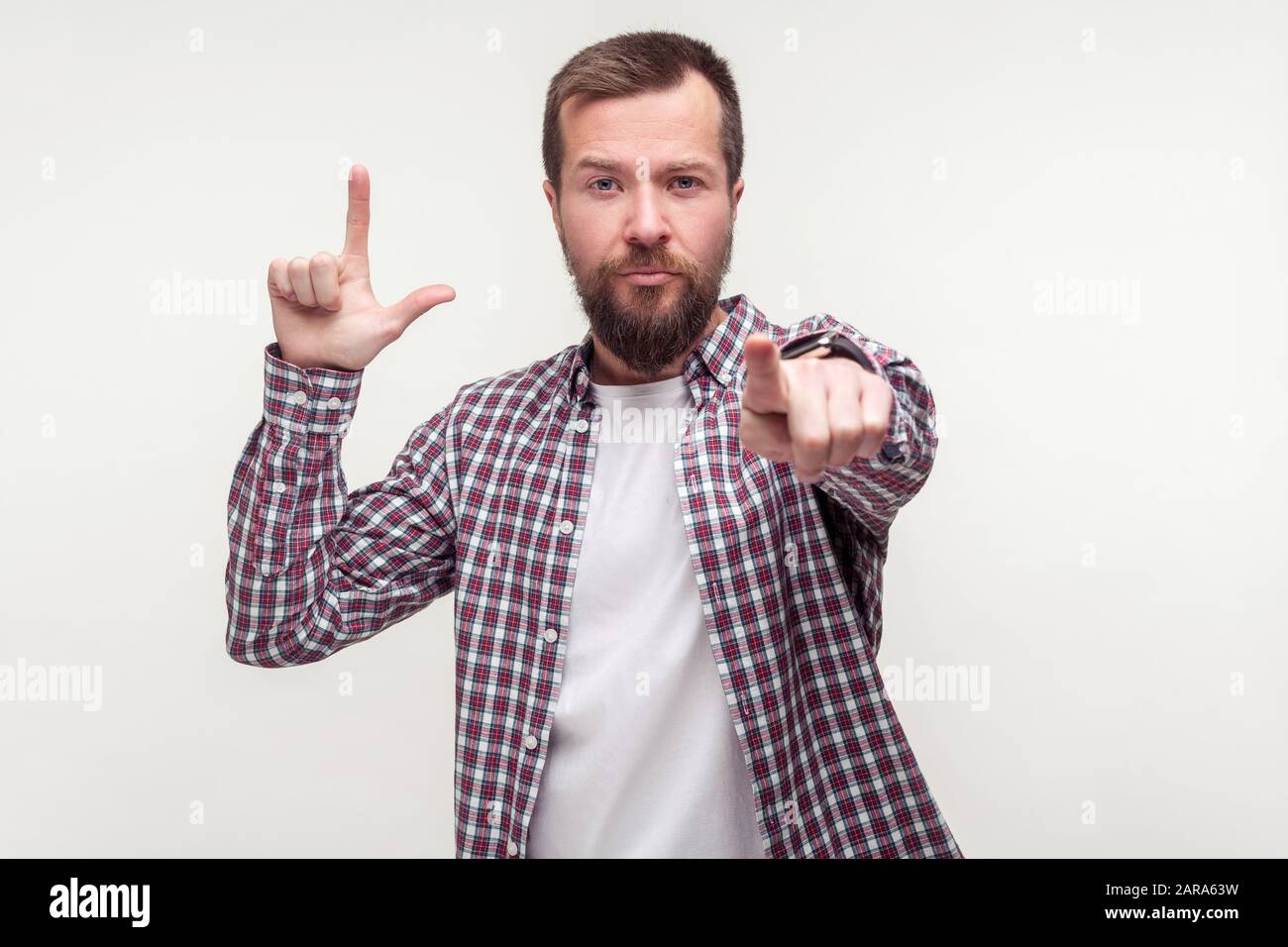 You are loser! Portrait of serious bossy bearded man in casual plaid ...