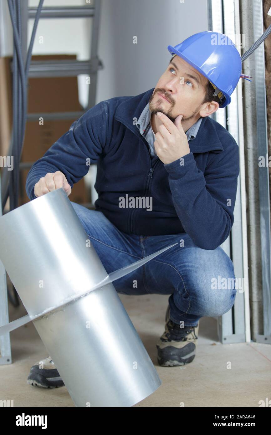 a plumber is repairing a pipe Stock Photo - Alamy