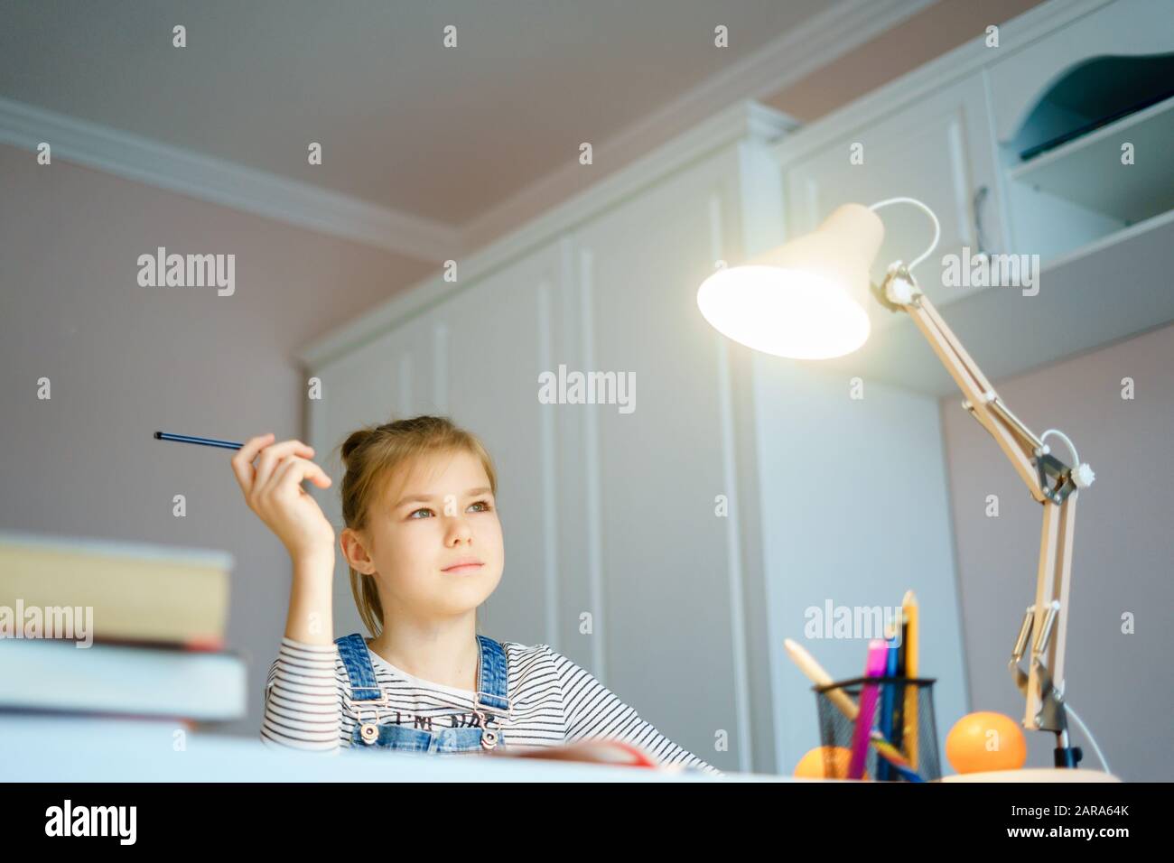 Beautiful girl working on her school project at home Stock Photo - Alamy