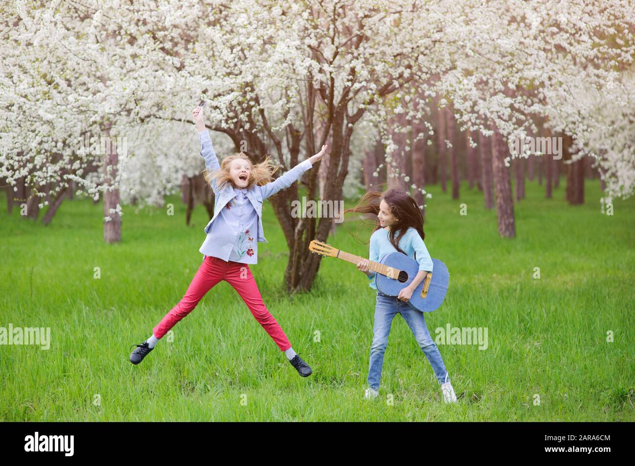 ecstatic live outdoor rock music concert by two little young girls ...
