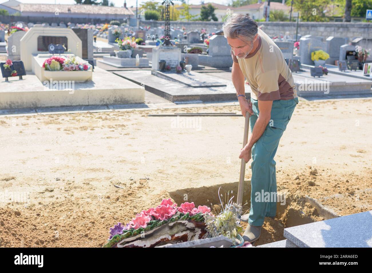 man digging at a graveyard Stock Photo - Alamy