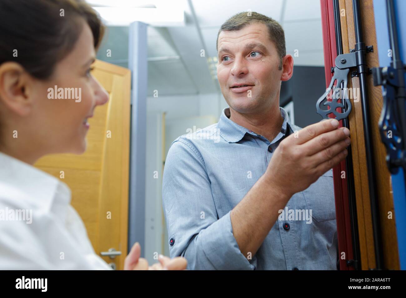 a couple chosing door handles Stock Photo - Alamy