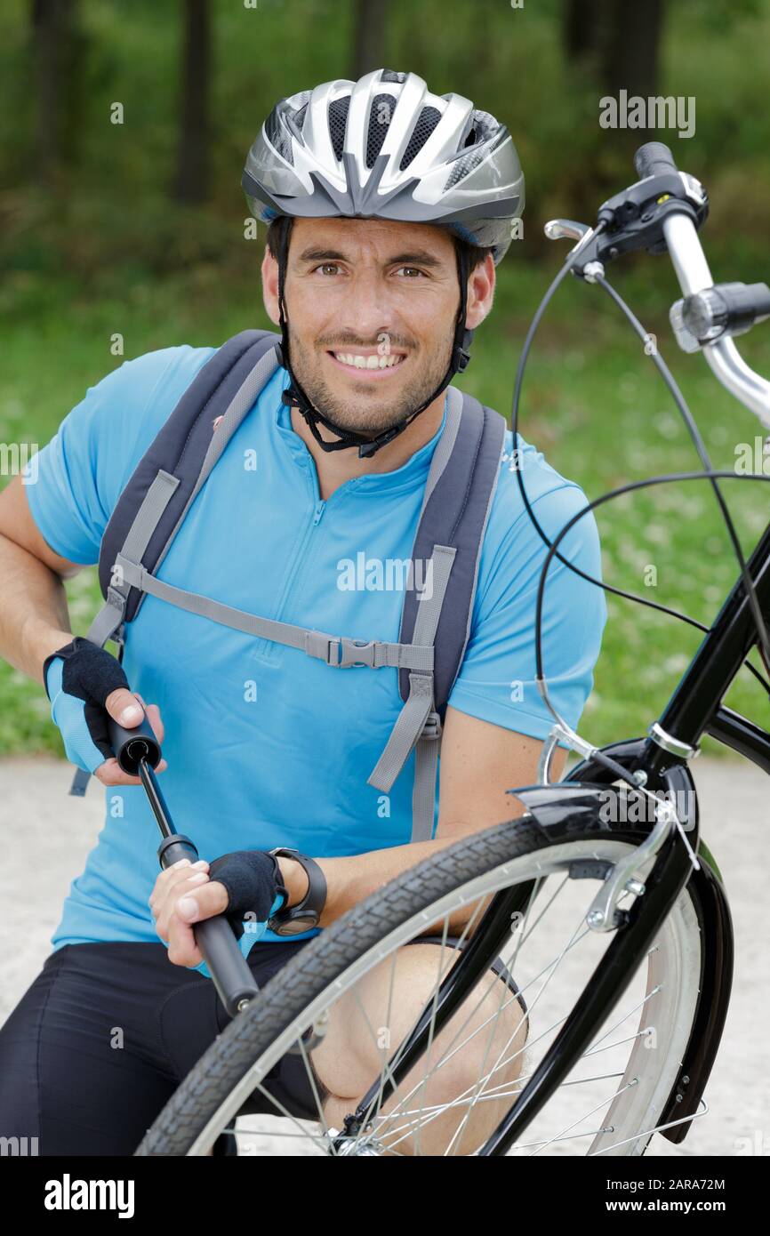 man pump up the bike wheel outdoor Stock Photo - Alamy