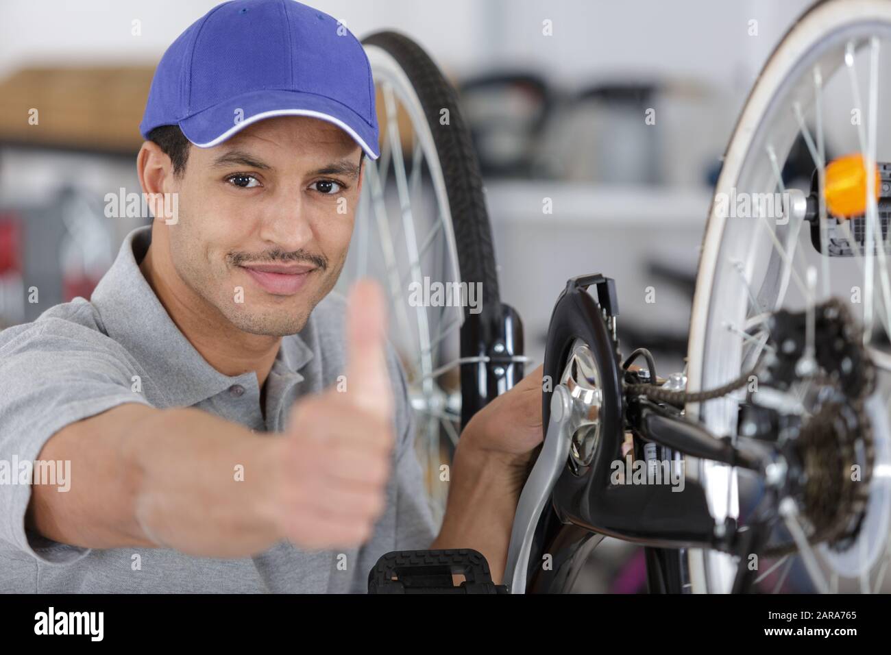 male technician fixing a bike Stock Photo - Alamy
