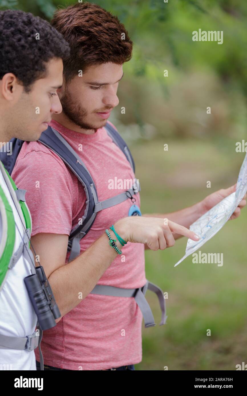 hiker with map exploring wilderness on trekking adventure Stock Photo ...