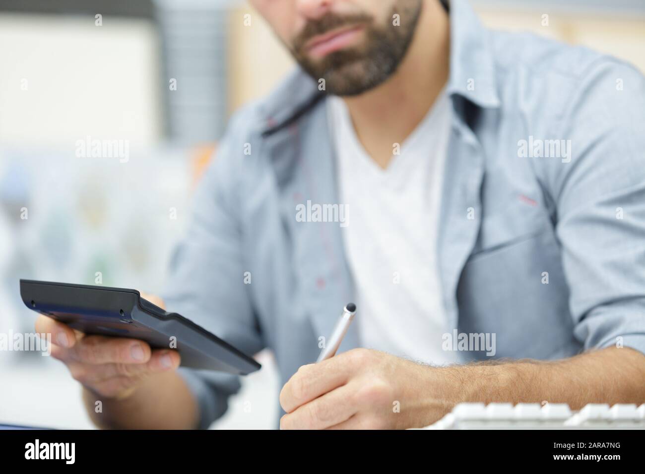 man using calculator in office Stock Photo - Alamy