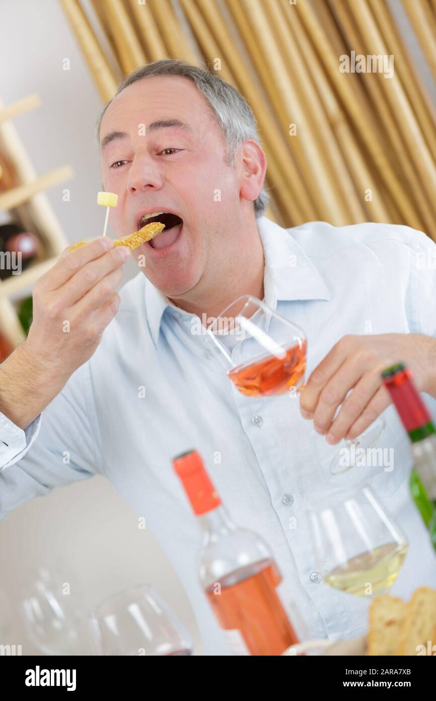 a man eating and drinking Stock Photo - Alamy