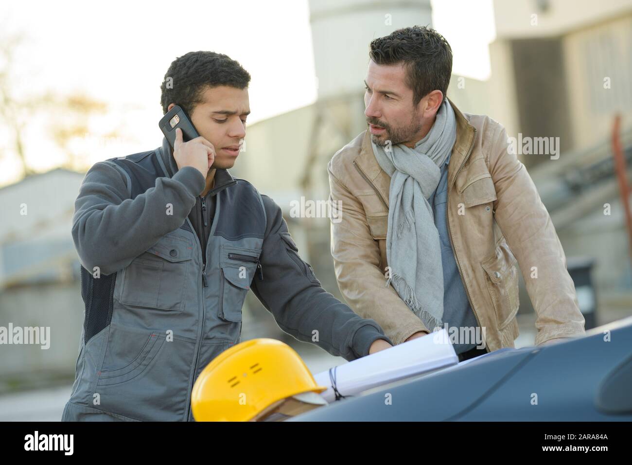 worker outside a construction site Stock Photo - Alamy