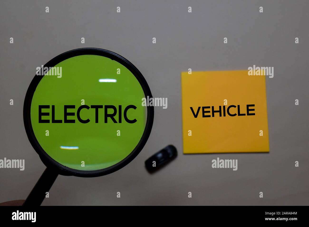 Electric or Vehicle write on a sticky note isolated on office desk ...