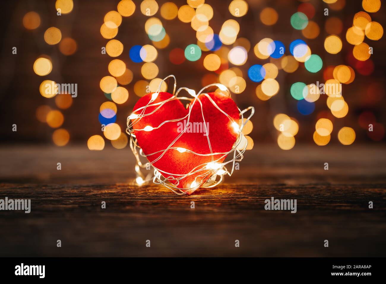 Red heart shape covered led lights on wooden and bokeh lights ...