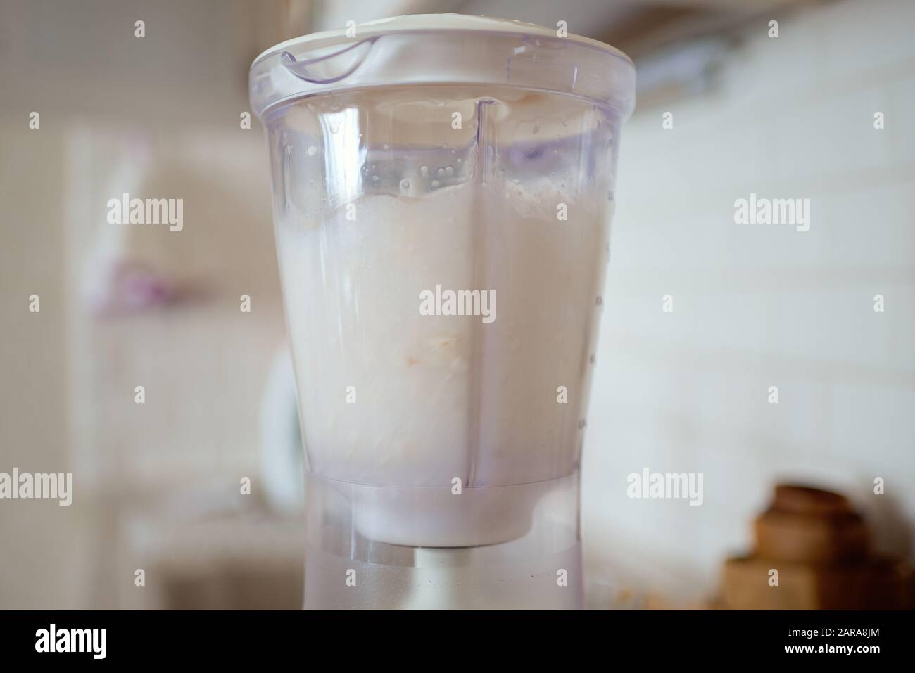 Blender and almonds soaked in water. Making healthy vegan milk Stock ...