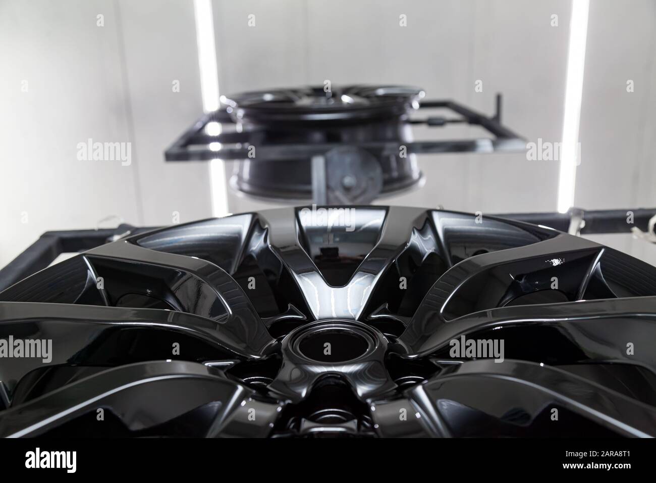 A Two black painted aluminum alloy wheel is mounted on a special frame ...