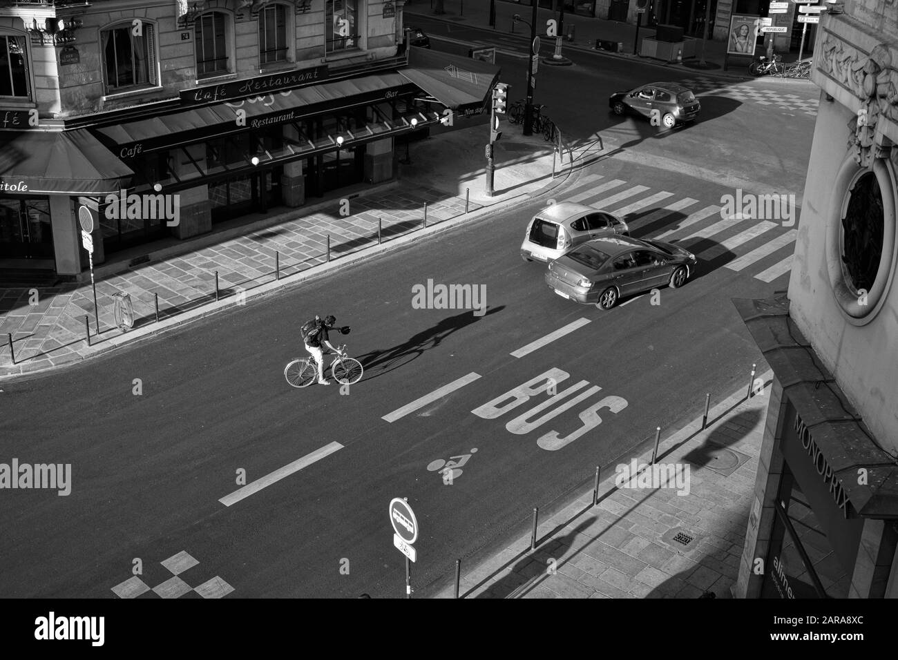 Aerial of bicycle and cars on road, long shadow, Paris, France, Europe ...