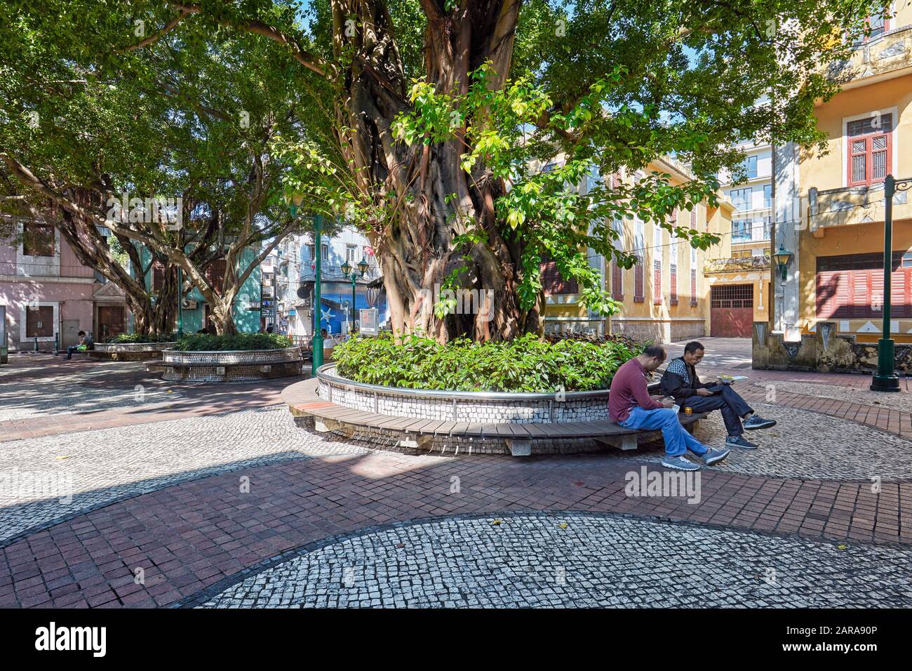 Men sitting in the shade on historic Lilau Square (Largo do Lilau ...