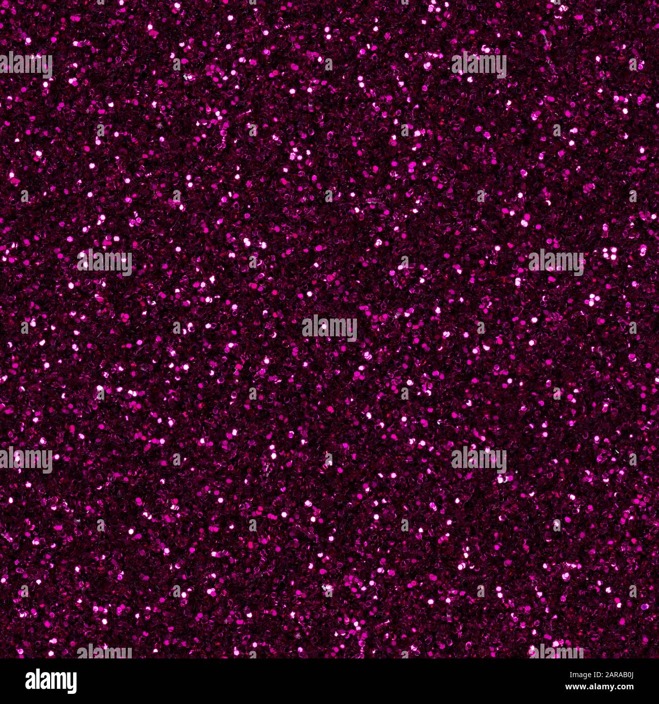 Shiny red, purple, fuchsia, magenta glitter, sparkle confetti texture. Christmas abstract ...