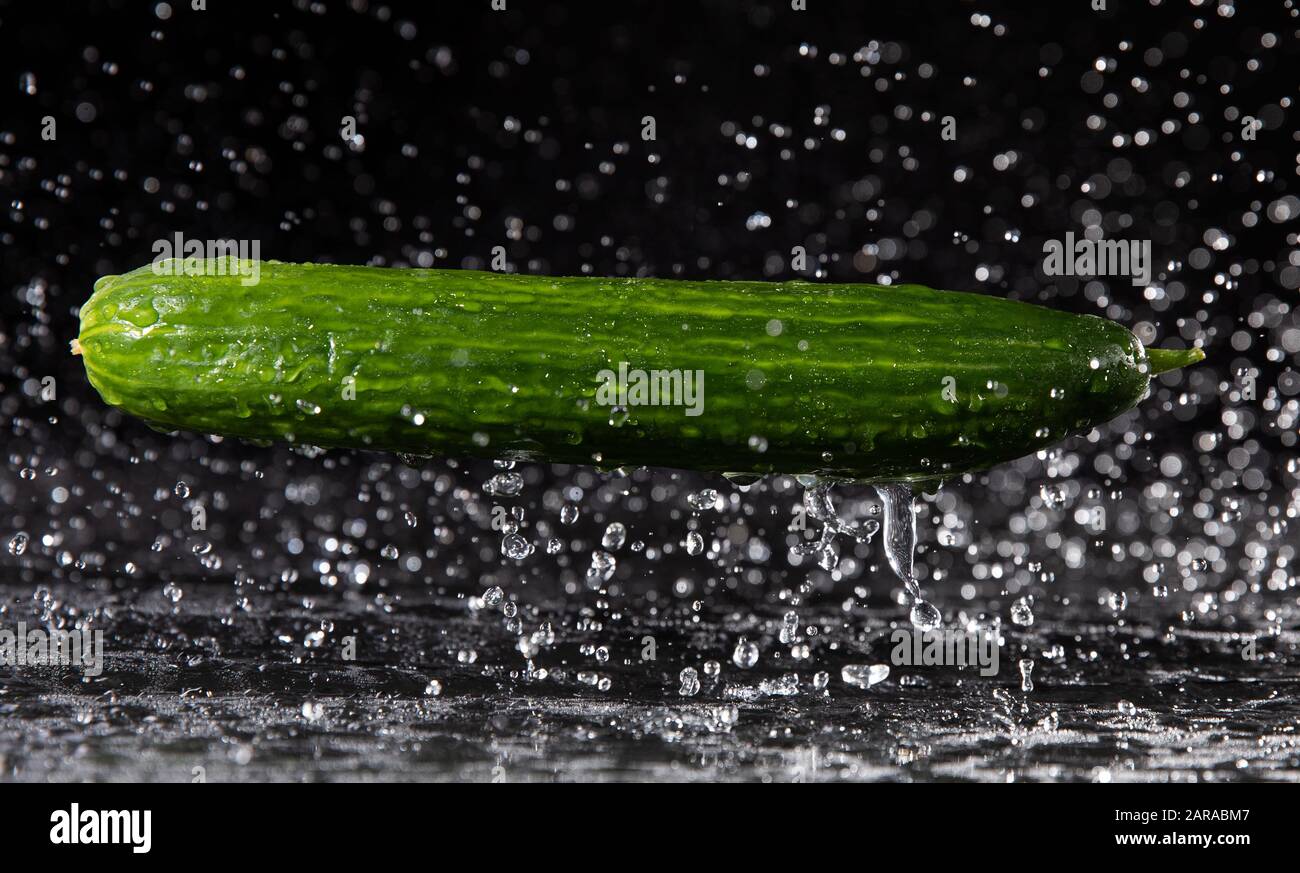 Sliced cucumber with splashing water or explosion flying in the air ...
